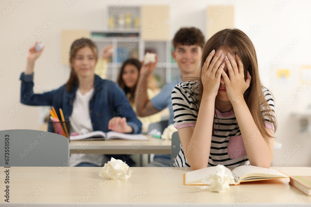 Teen problems. Students bullying their classmate in classroom ...