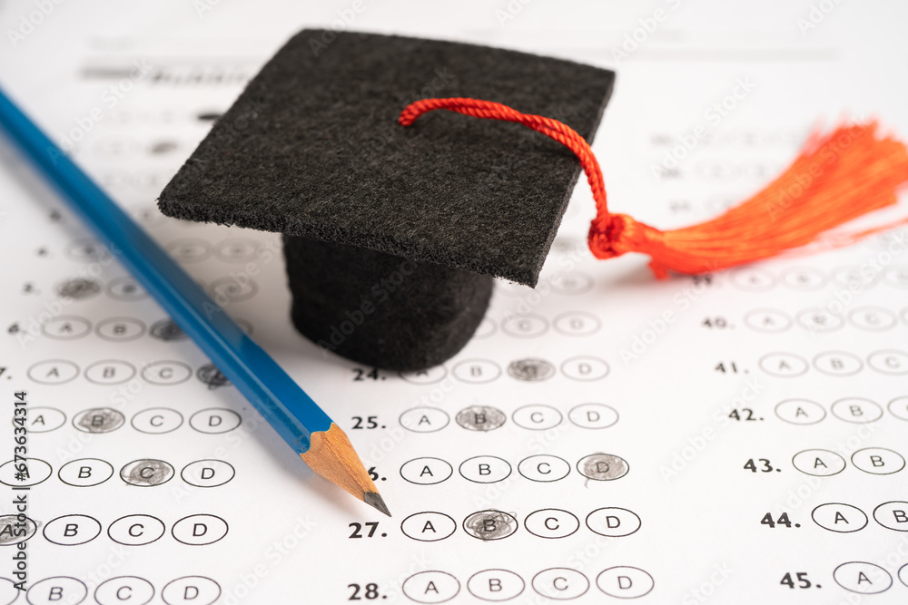 Graduation gap hat and pencil on answer sheet background, Education ...