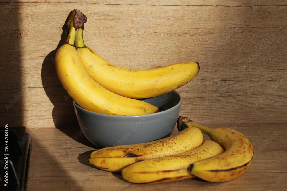 Bananas on wooden kitchen counter. Ripe bananas isolated on table ...