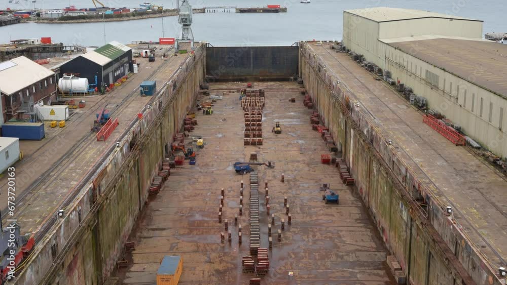 Big empty dry dock in Falmouth shipyard, with industrial equipment and ...