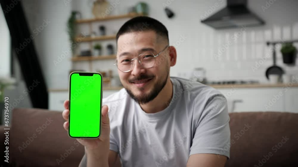Man Showing Cellphone Green Screen At Camera. Smiling Asian man holding ...