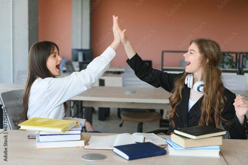 Education. Two clever modern students in black and white uniform study ...