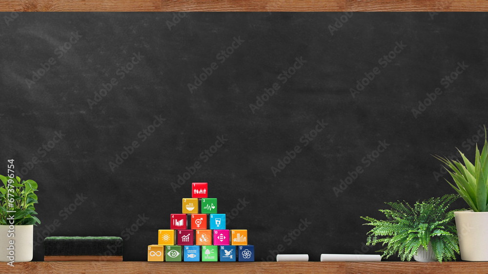 Sustainable Development global goals cube set besides of Blackboard in ...