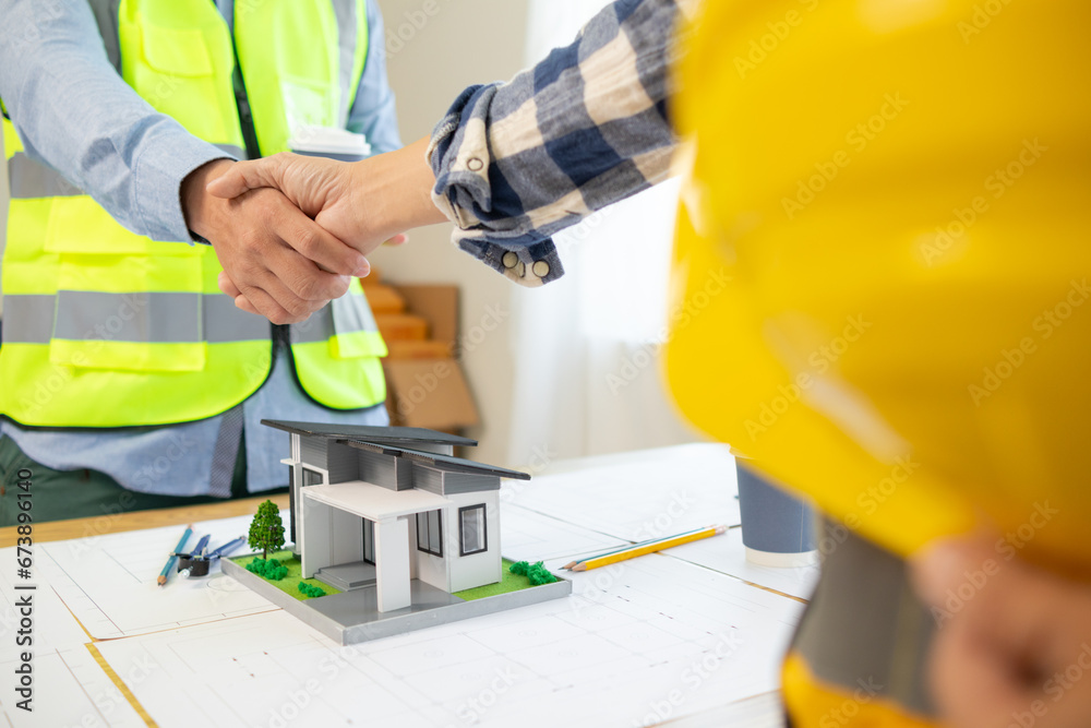 Architects and construction engineering handshake after meeting discuss ...