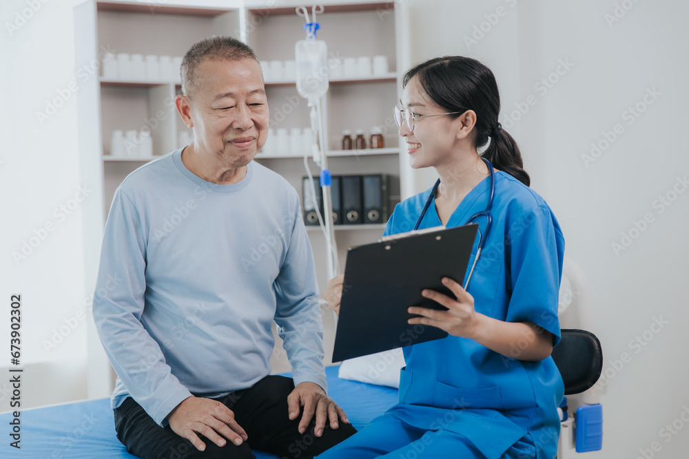 Beautiful Asian female nurse in a nursing uniform talks to a senior ...