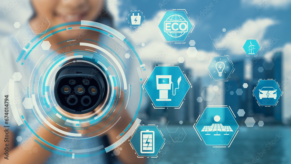 Focus young girl pointing EV charger in front of camera display eco ...