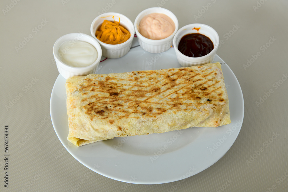 Lavash doner kebab ( zurna doner durum ) or shawarma sliced in plate ...