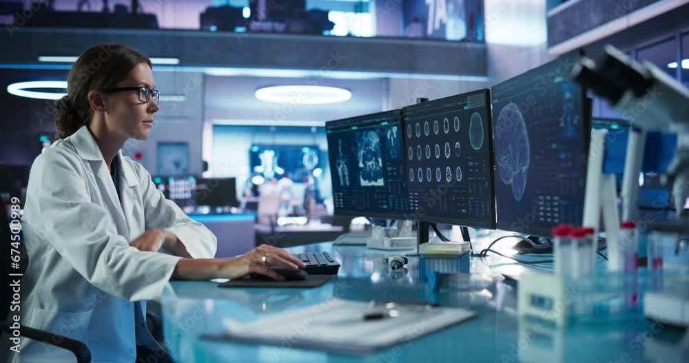 Caucasian Female Neuroscientist Using Desktop Computer To Analyze MRI Scans Of Human Brain In ...