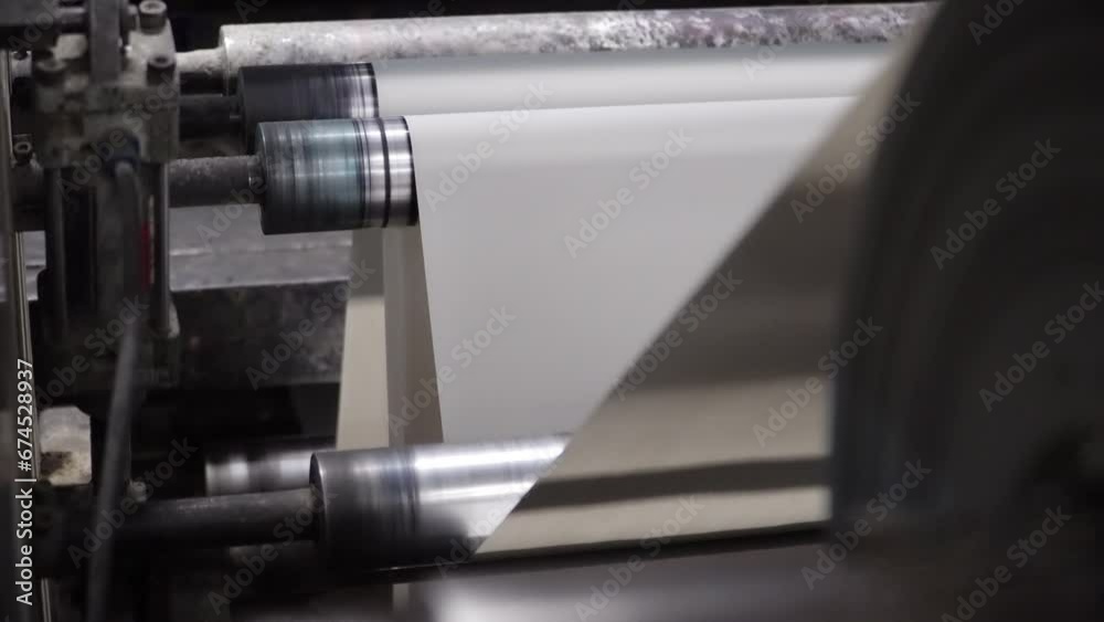 Close up view of a paper running through the printing machine during ...