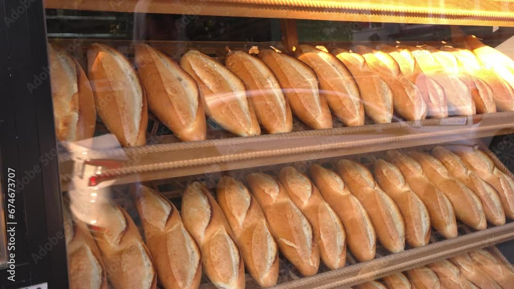 Exterior view of bakery glass display case. Freshly baked bread, rolls ...