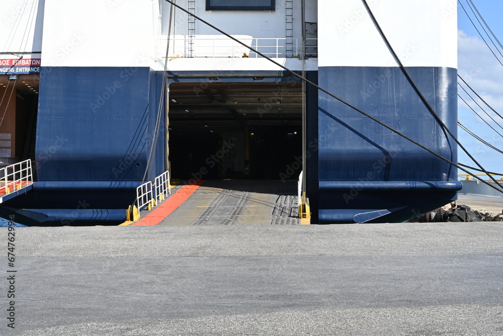 Passenger ferry with blue and white hull and open stern ramp and aft ...