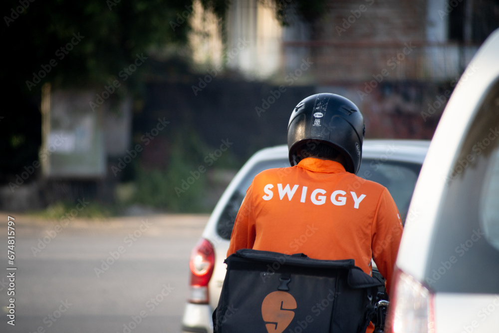 swiggy food delivery rider wearing jacket travelling for the foodtech ...
