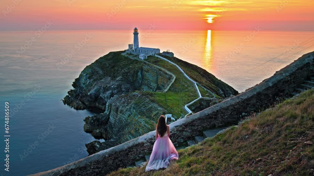 Beautiful woman in a dress visits South Stack Lighthouse at golden ...