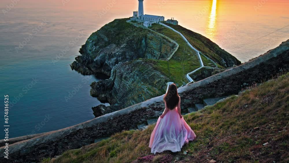 Video „Beautiful woman in a dress visits South Stack Lighthouse at ...