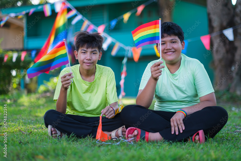 LGBTQ community celebrating pride month, two young asian kids holding ...