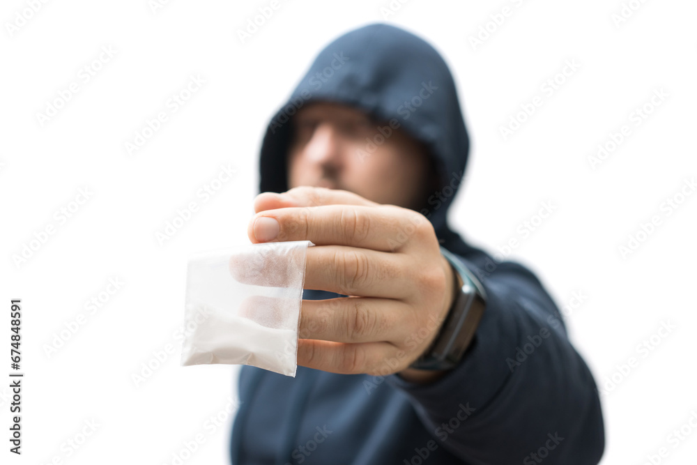 Criminal man in a hood holds transparent plastic bag with white powder ...