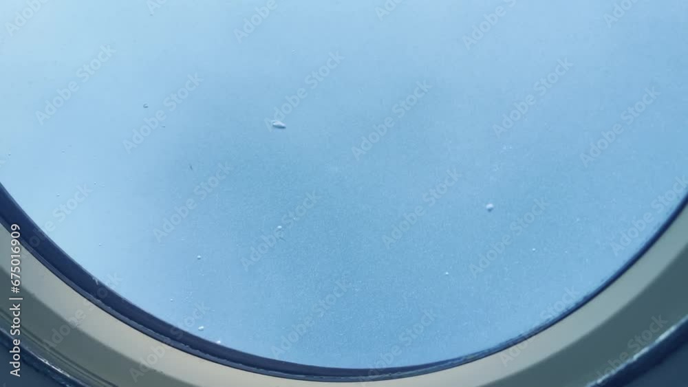 Cinematic wide shot of a flurry of air bubbles from the porthole as a ...