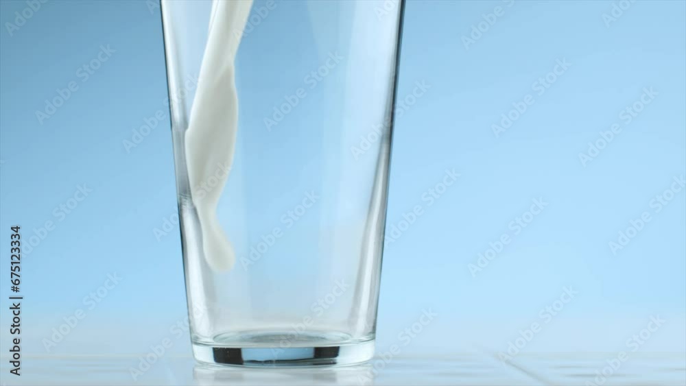 Milk flowing in Super Slow Motion scene into a glass, fresh Milk ...