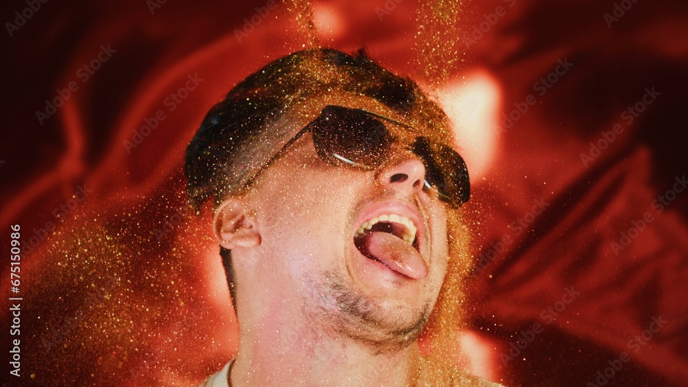Crazy fun man sprinkles himself with sparkle particles. Fun photo funny ...