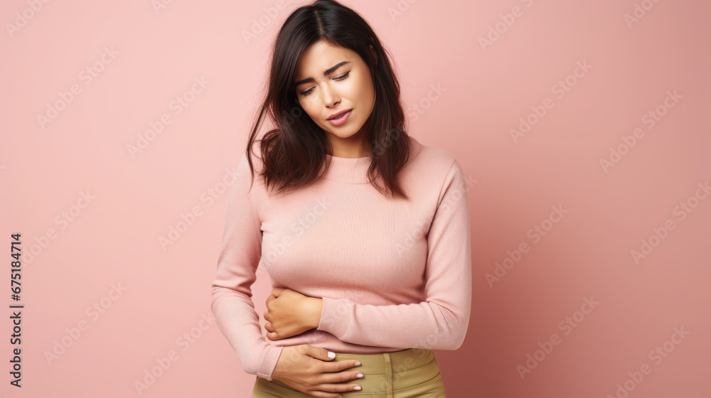 sad young woman holding her stomach, illness, cramps, health, color ...