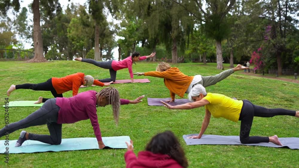 Multiracial people with different ages doing yoga exercise together at ...