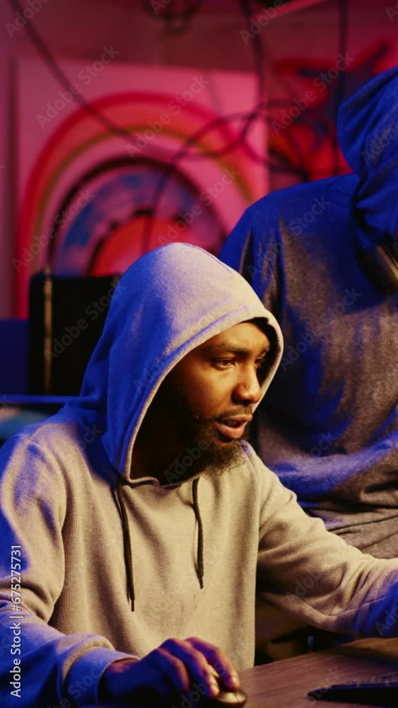 Vertical video New member in hacking group receiving guidance from knowledgeable rogue ...