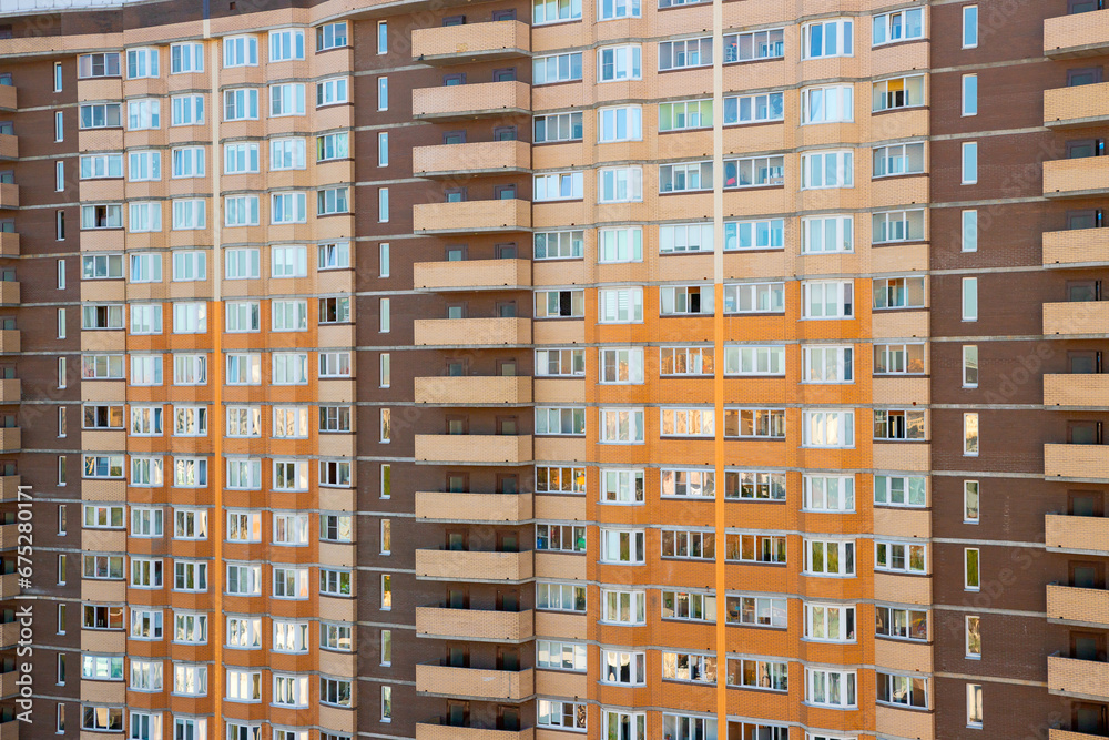 brown orange brick wall of multi-storey apartment building, full frame ...