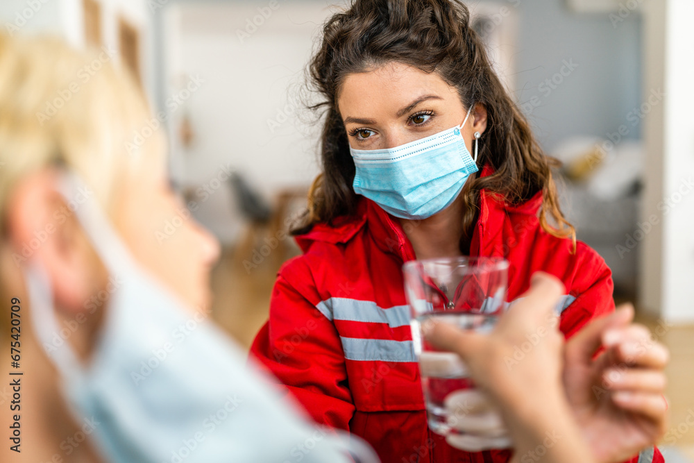 Portrait of female helpful paramedic doctor in uniform taking care of ...