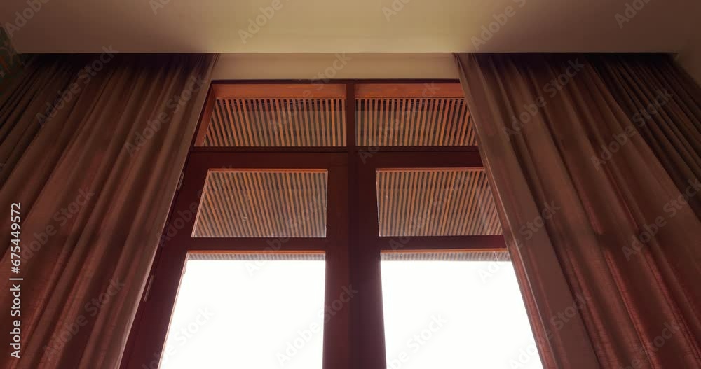 Heavy curtains closing automatically, low angle shot of top part of the ...