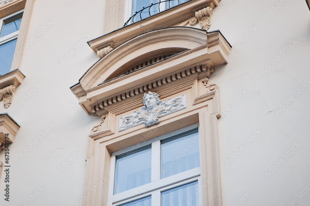 Window with wooden frame. Neoclassical building of complex design with ...