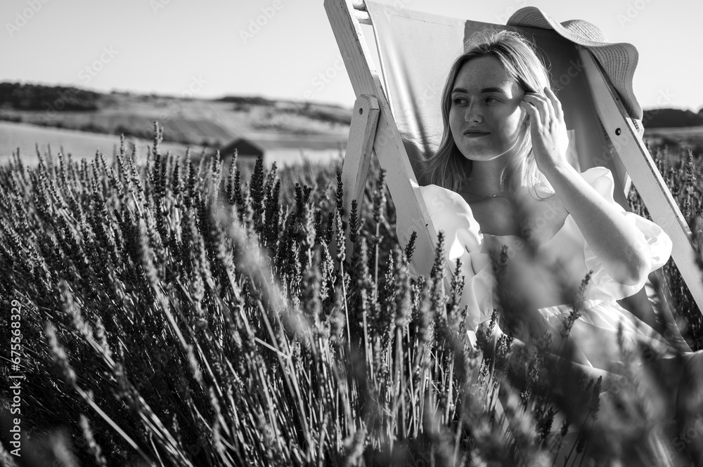 Black And White Photo Relaxed Young Girl In A White Dress Sitting In A