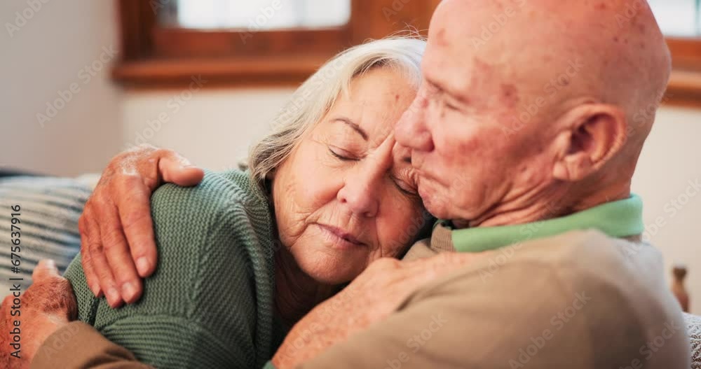Love, support and hug with a senior couple on a sofa in the living room ...