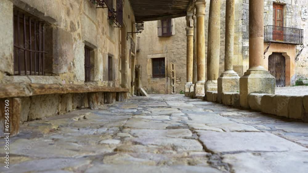 Cobbled floor with very old stone slabs and stone columns in Pedraza ...