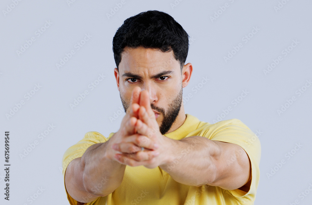 Finger gun, pointing and portrait of man in studio with aim for target ...