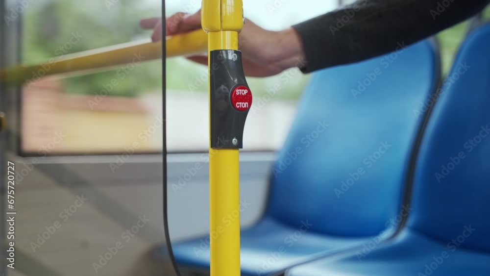 Close up shot man stands up to push red stop button on handrail in ...
