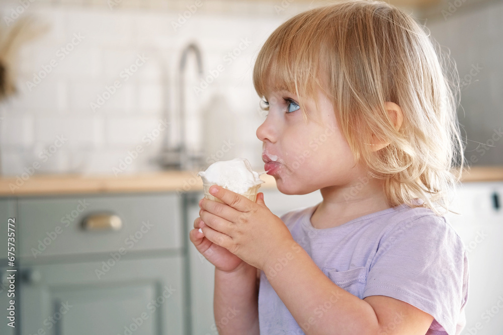 Baby girl enjoying ice cream. Pretty little toddler eating an ice-cream ...