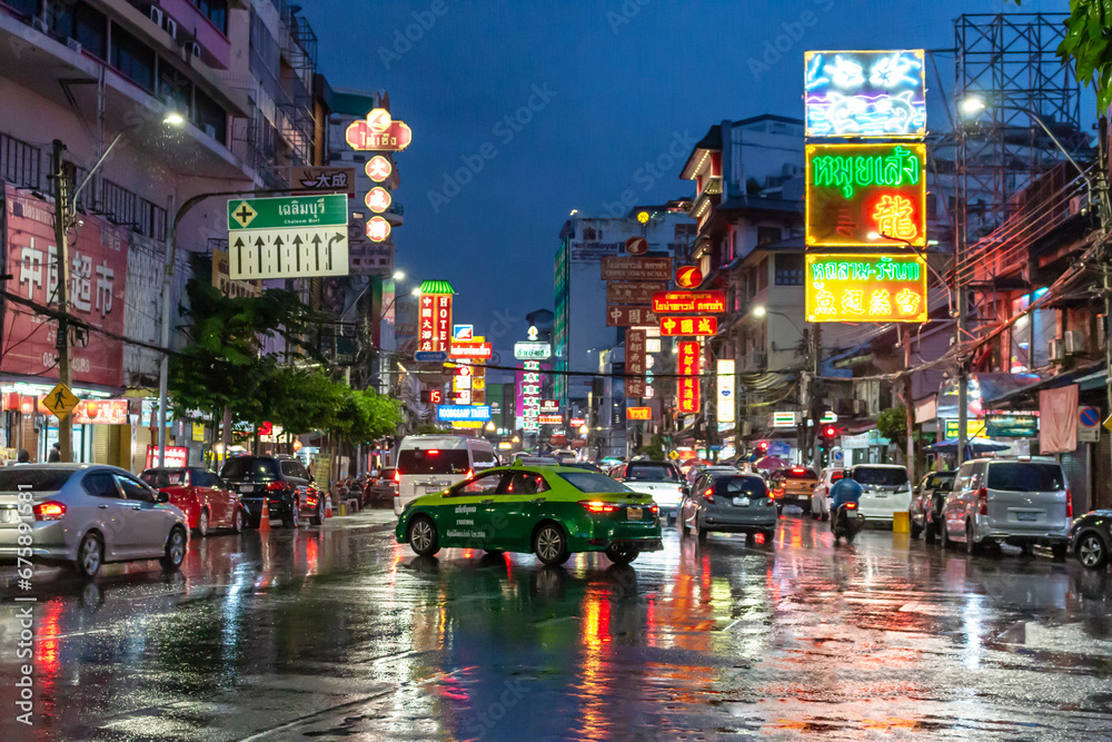 Cars and shops on Yaowarat Road. Chinatown, with its distinctive Chinese buildings, restaurants ...