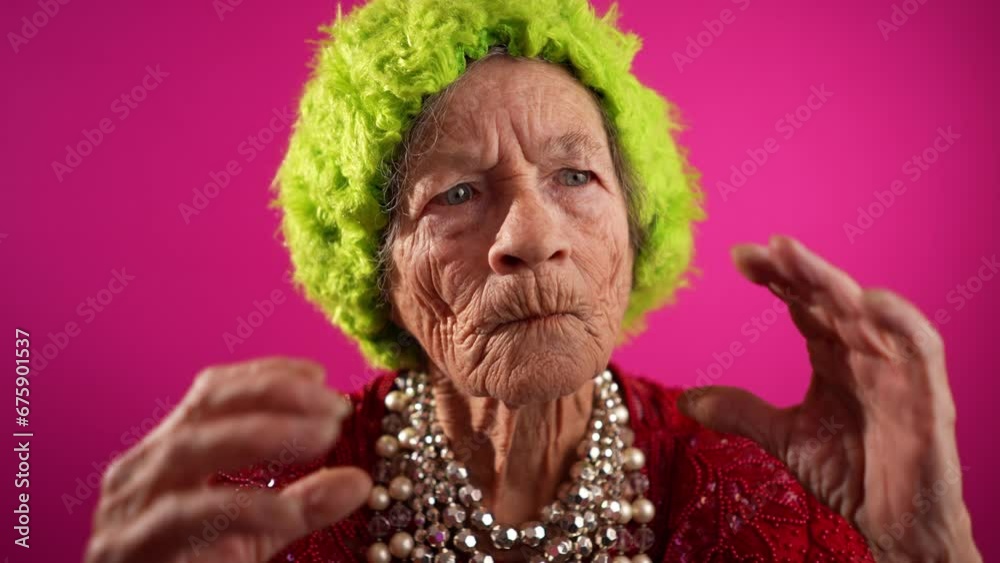 Funny elderly senior old woman with no teeth and wrinkled skin gives ...