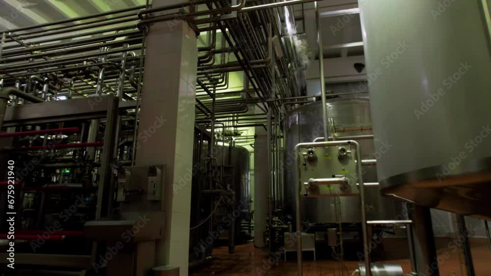 Giant metal tanks and light steam in chemicals manufacturing workshop ...