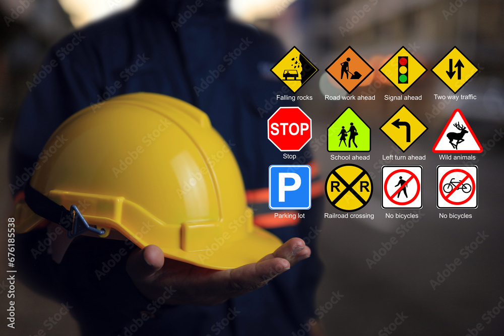 Traffic safety staff holding yellow helmet and road warning sign to ...
