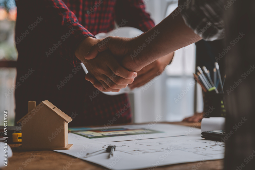 Architect and engineer construction workers shaking hands after ...