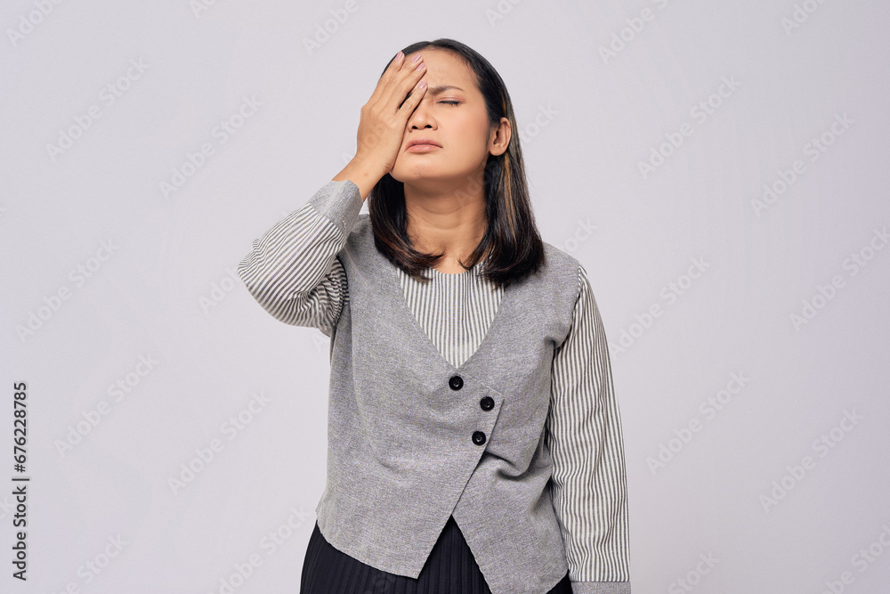 Forgetful young Asian woman in casual clothes slapping hand on her head ...