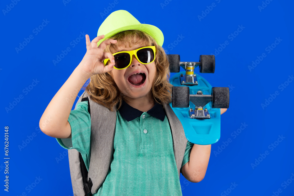 Excited child. Child with skateboard in the studio. Kid having fun with ...