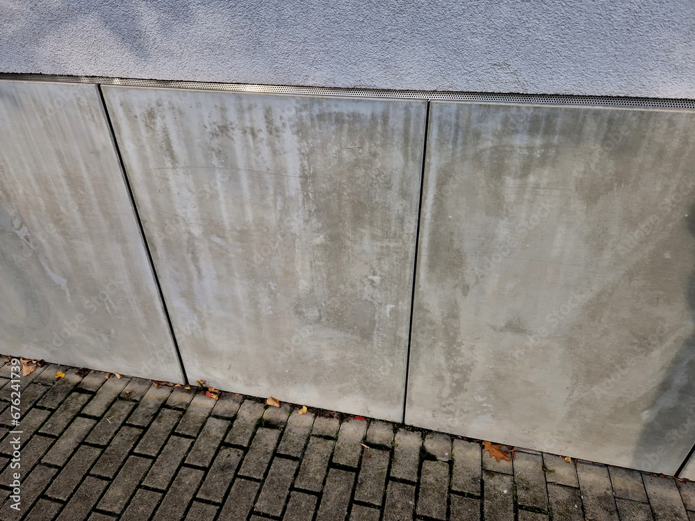 cladding of the house consists of concrete slabs with gaps with a ...