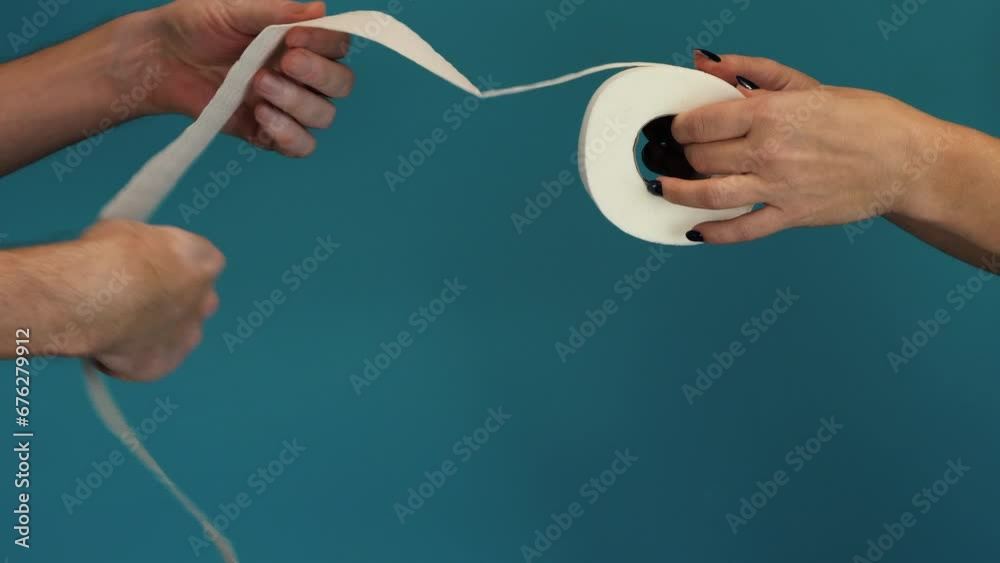 Closeup hand pulling toilet paper roll in holder for wipe, woman ...