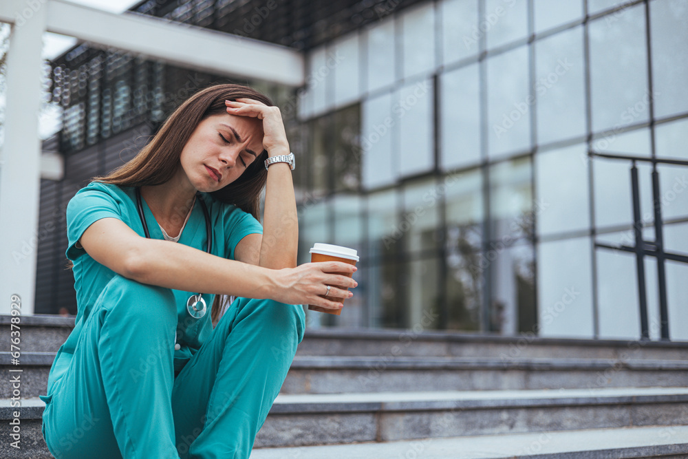Worried and stressed doctor sitting on stairs. It's stressful work ...