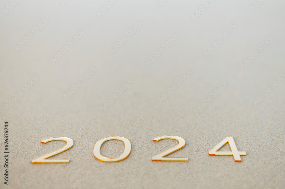 gold numbers 2024 on the sand by the sea Stock Photo | Adobe Stock