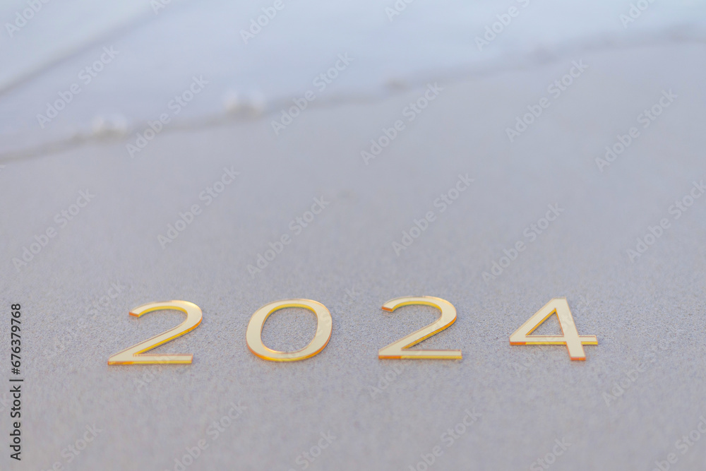 gold numbers 2024 on the sand by the sea Stock Photo | Adobe Stock
