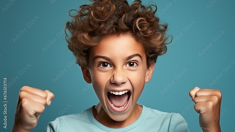 Child celebrating an achievement with his fists raised and shouting ...