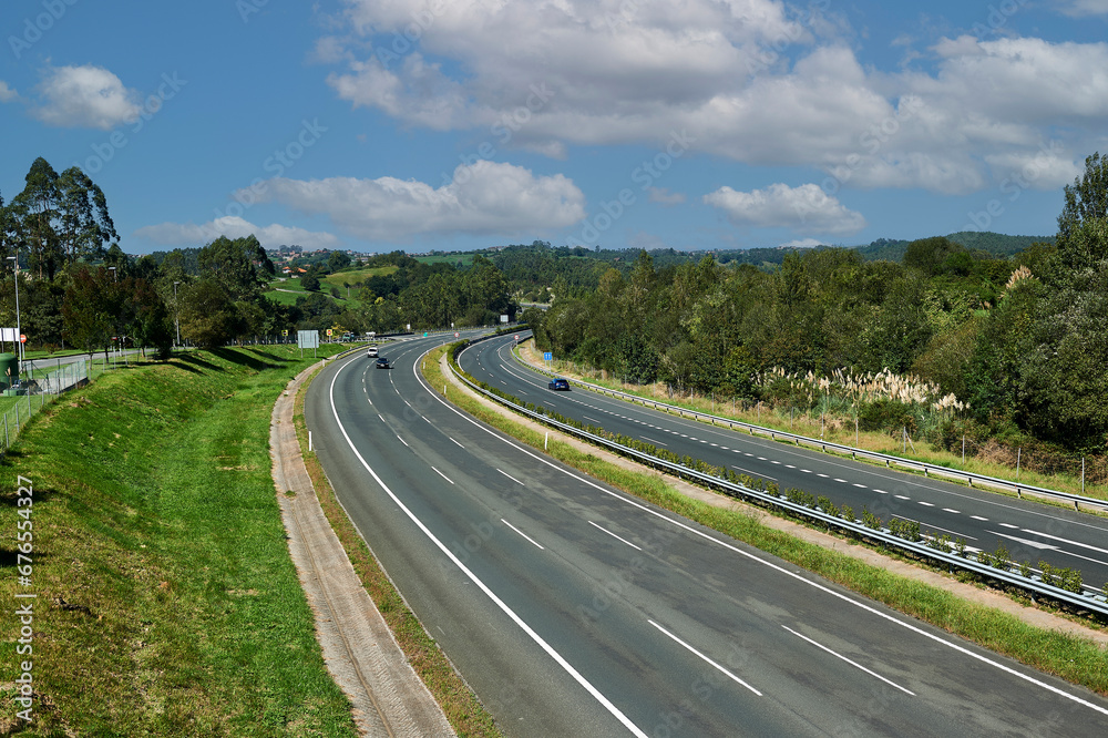 open curve on the A8 Cantabrian highway with three lanes in each ...